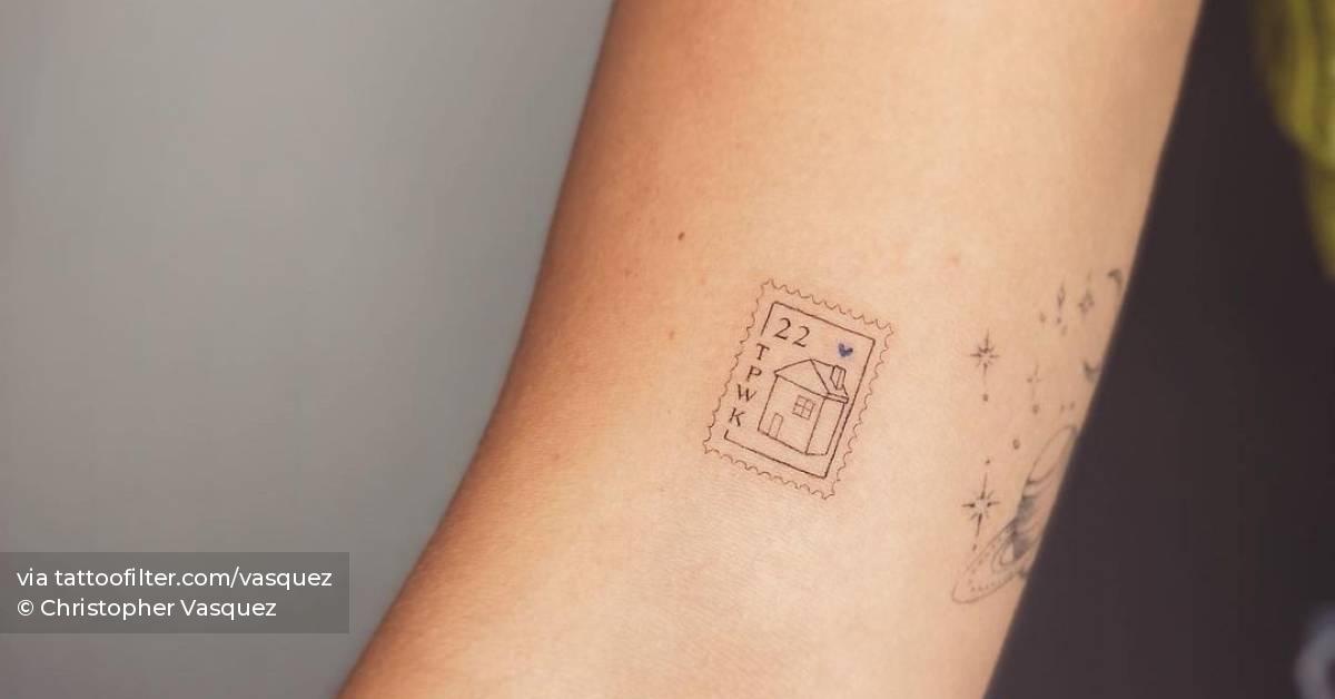 Fine line house stamp tattoo located on the bicep.