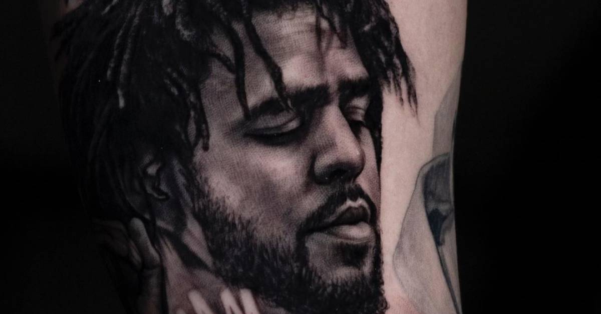 Micro-realistic style J.Cole portrait tattoo located on