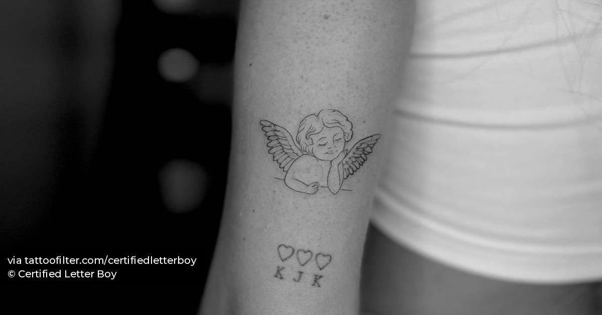 Fine line cherub tattoo located on Megan