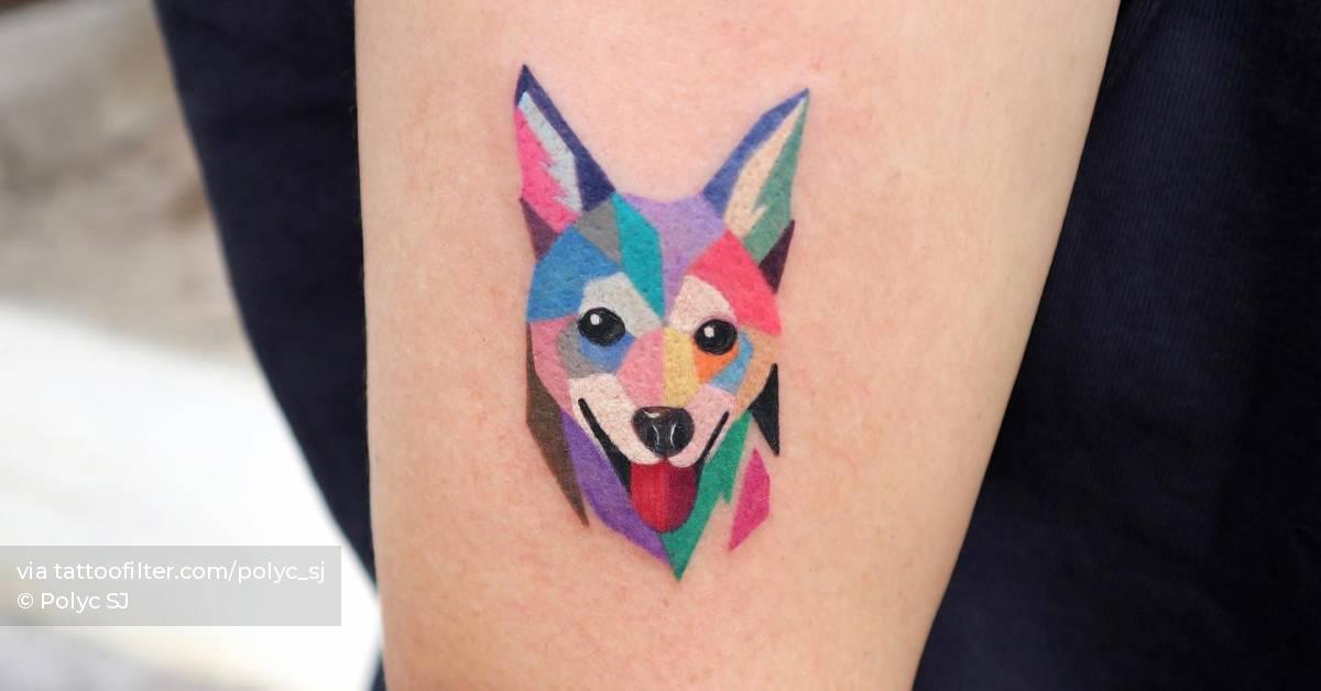 Low poly dog portrait tattoo located on the upper arm.