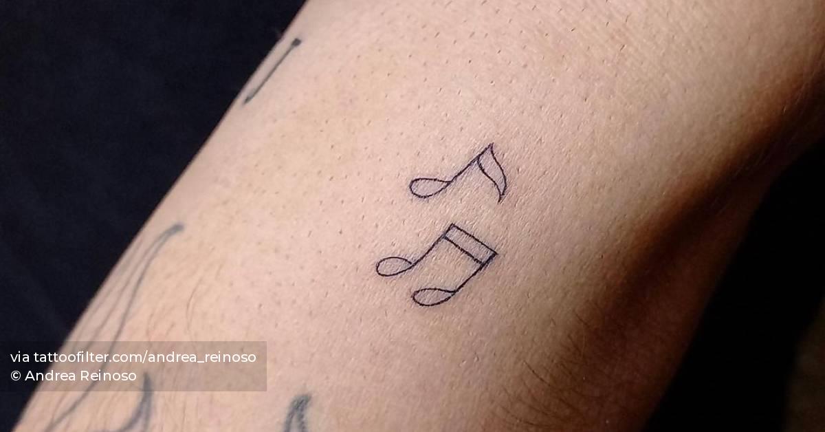 FIne line music notes tattoo located on the forearm.