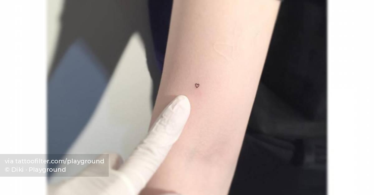 Micro heart tattoo located on the bicep.