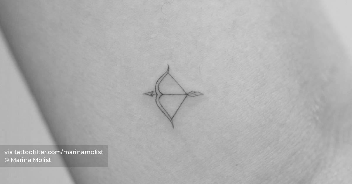 Fine line bow and arrow tattoo located on the inner