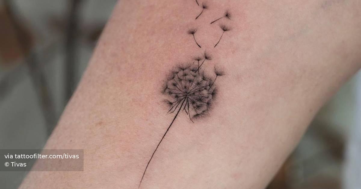 Micro-realistic style dandelion tattoo located on the