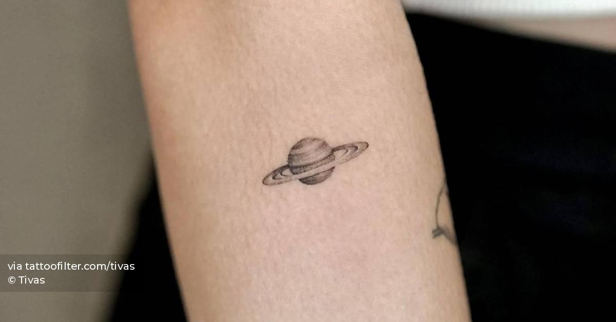 Micro-realistic style Saturn tattoo located on the