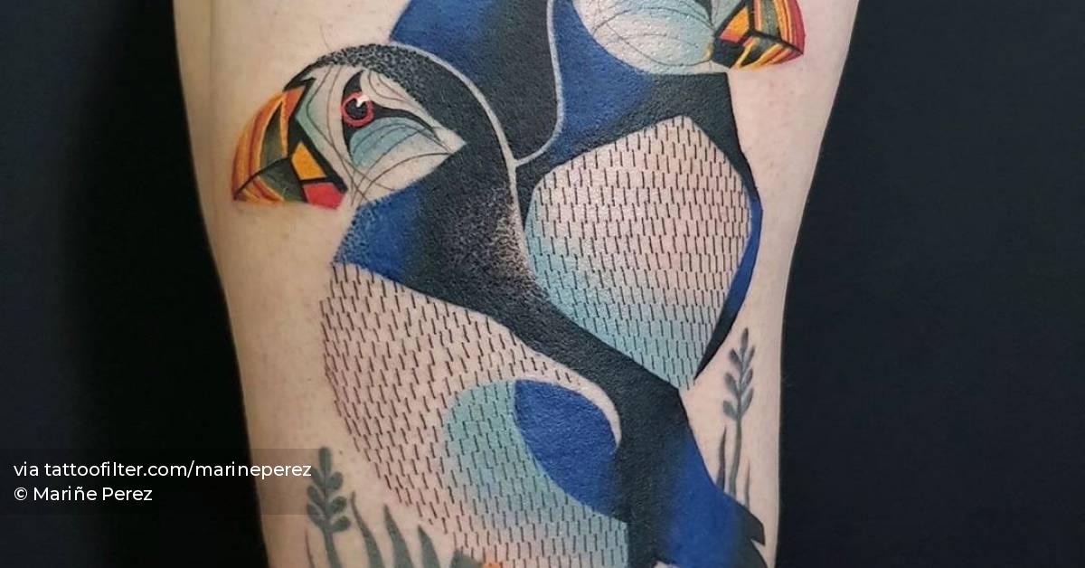 Large puffins tattoo located on the thigh.