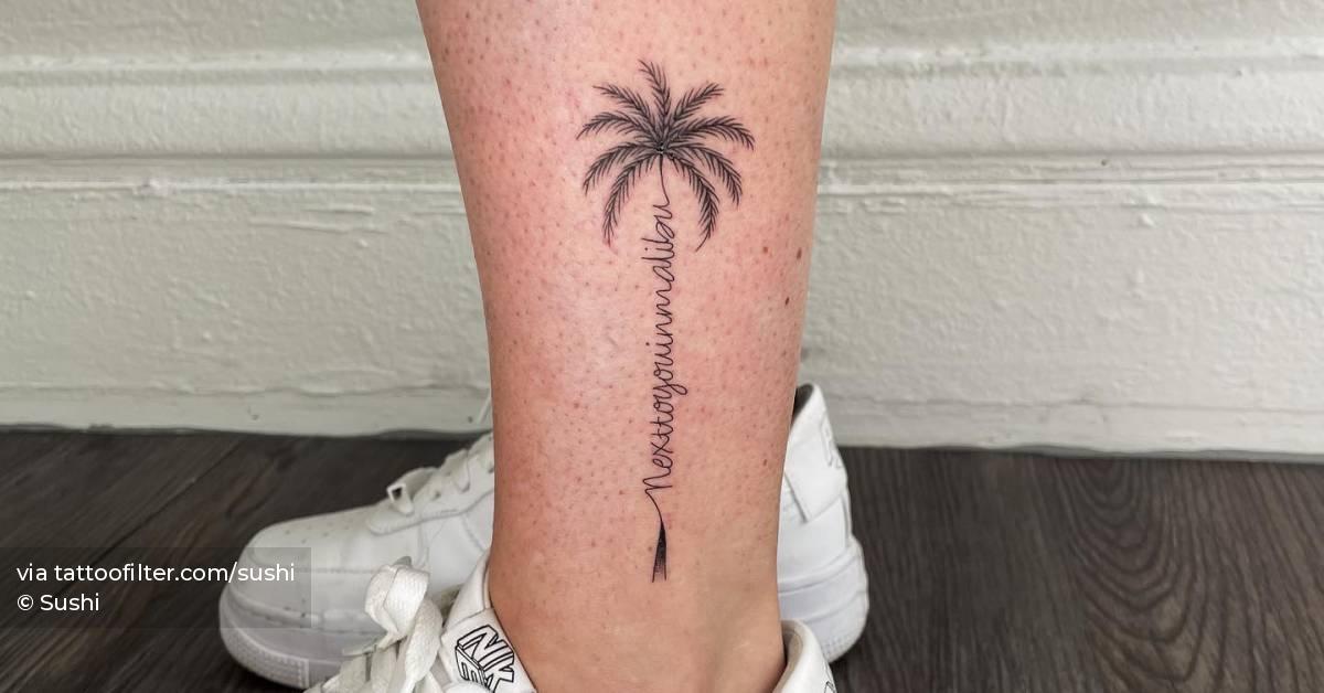 Palm tree lettering tattoo located on the ankle.