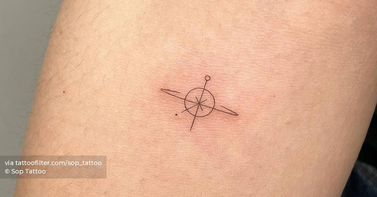 Minimalistic fine line Saturn tattoo located on the