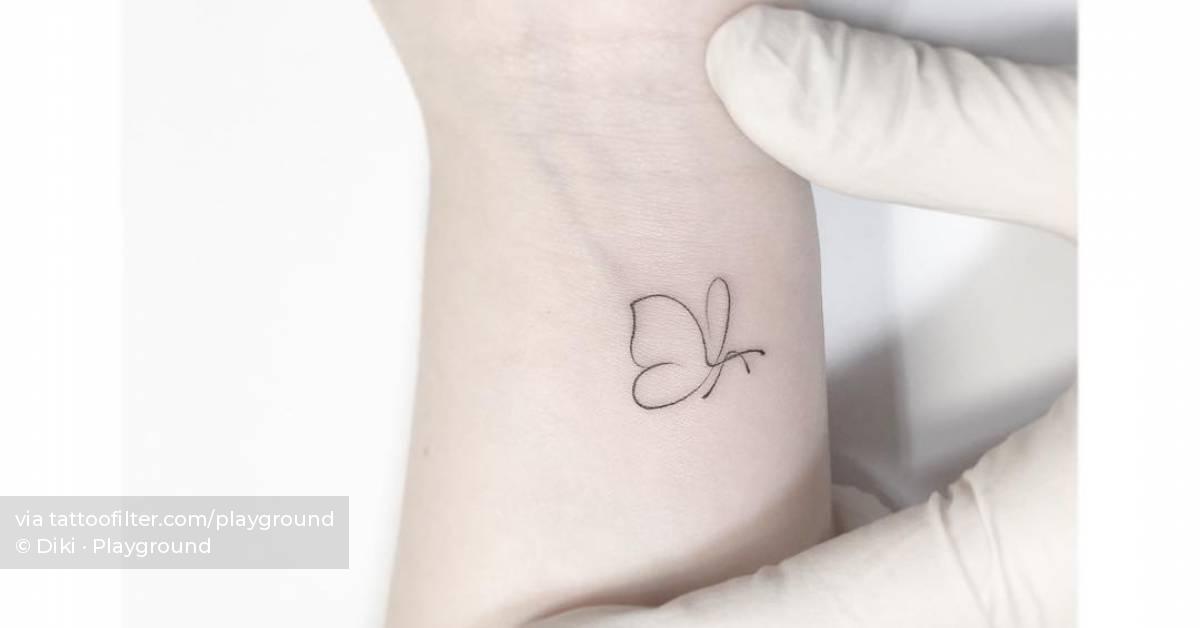 Fine line butterfly tattoo located on the wrist.