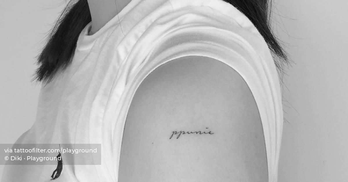 Handwritten lettering tattoo located on the upper arm.