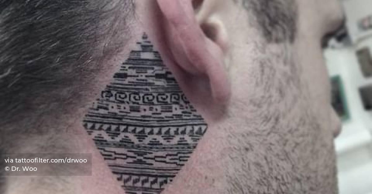 Op art tattoo located behind the ear.