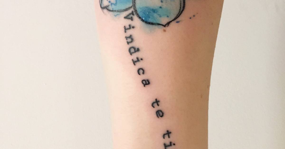 Forearm tattoo saying "Vindica te tibi" (Latin for
