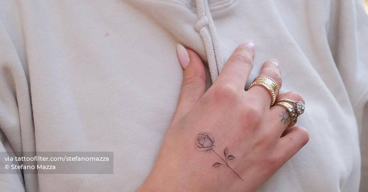 Micro-realistic rose tattoo located on the hand.