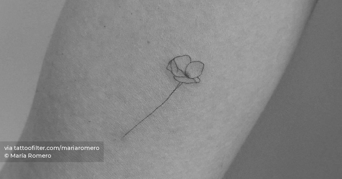 Fine line poppy flower tattoo located on the inner arm.
