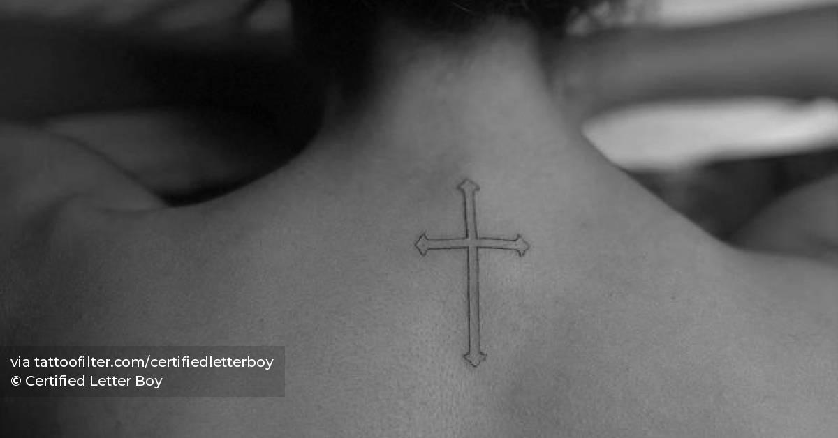 Fine line cross tattoo located on Abby Elinsky's upper