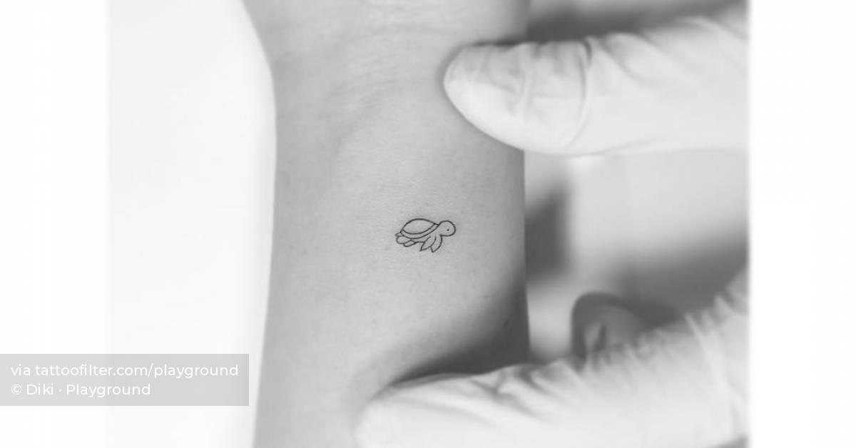 Fine line turtle tattoo placed on the wrist,