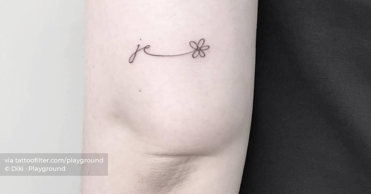 Initials and flower tattoo located on the tricep.