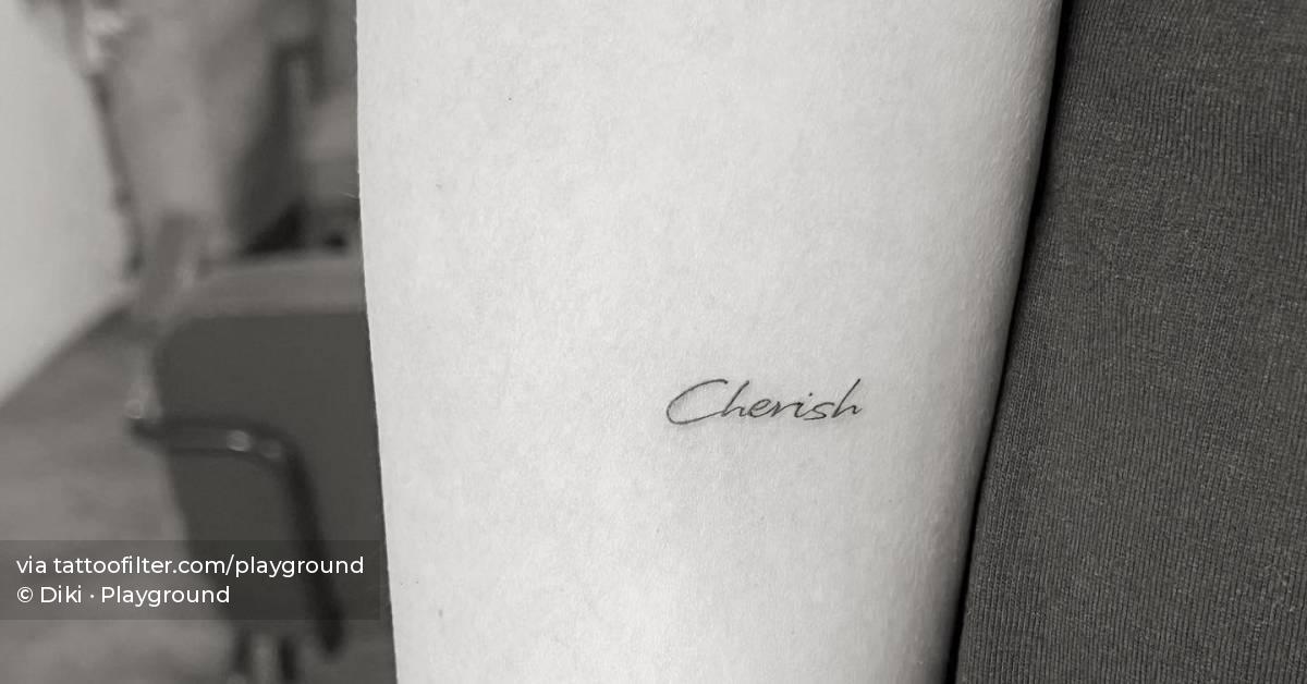 "Cherish" lettering tattoo done on the upper arm.