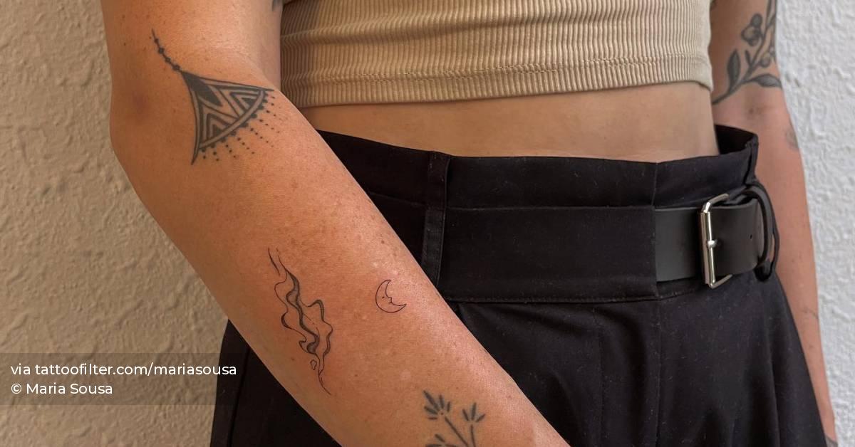 Fine line crescent moon and abstract lines tattooed on