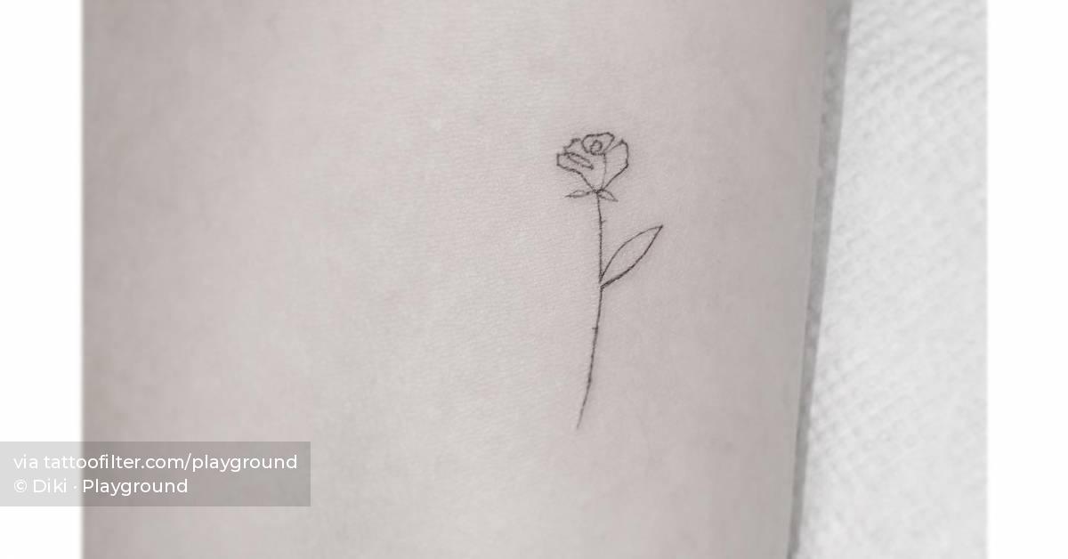 Fine line rose tattoo located on the inner forarm.