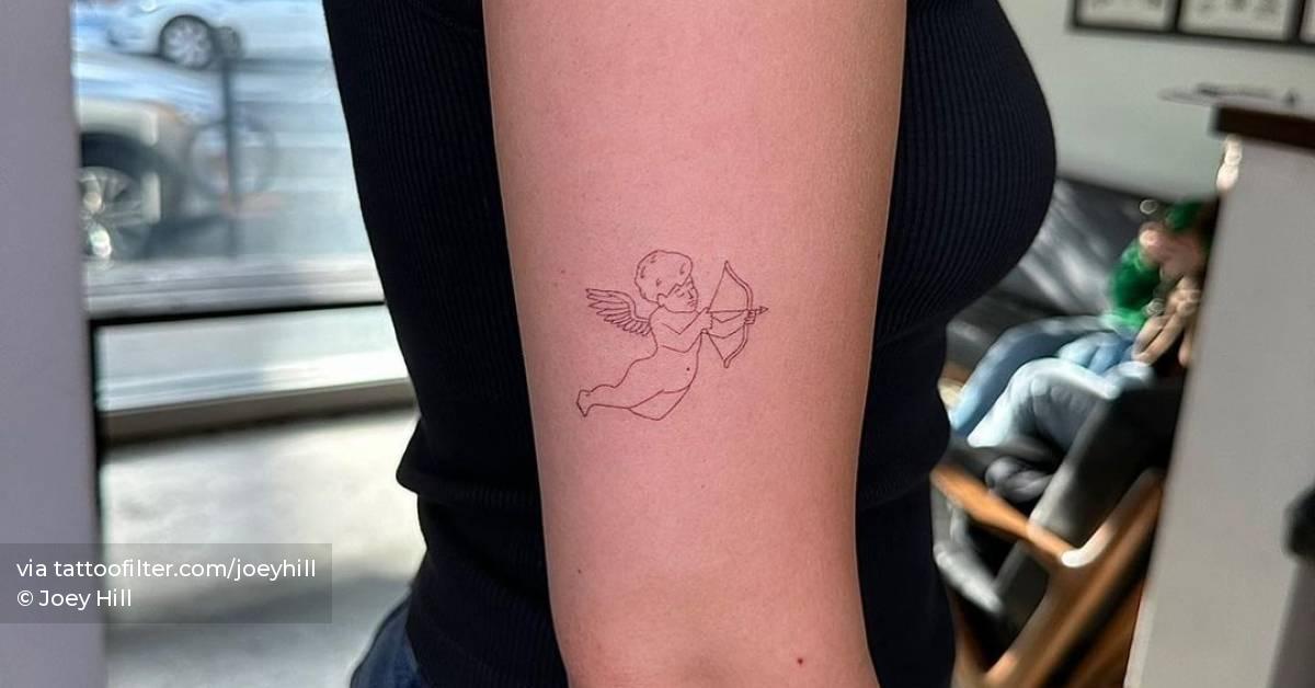 Single needle cupid tattoo done on the upper arm.