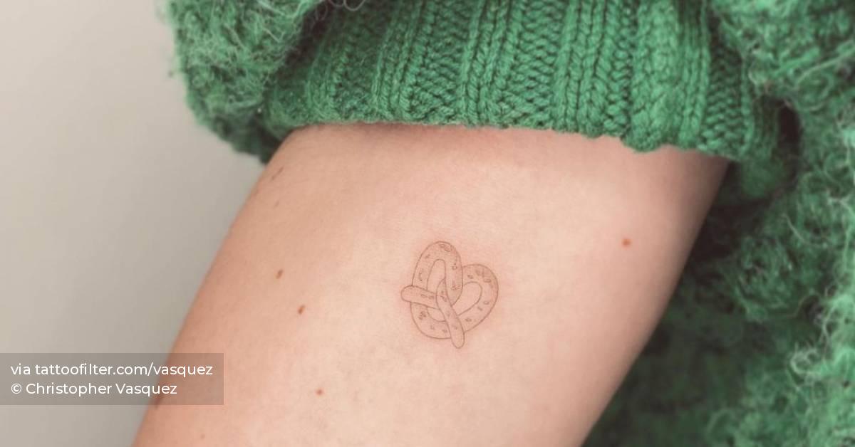 Fine line style pretzel tattoo located on the inner