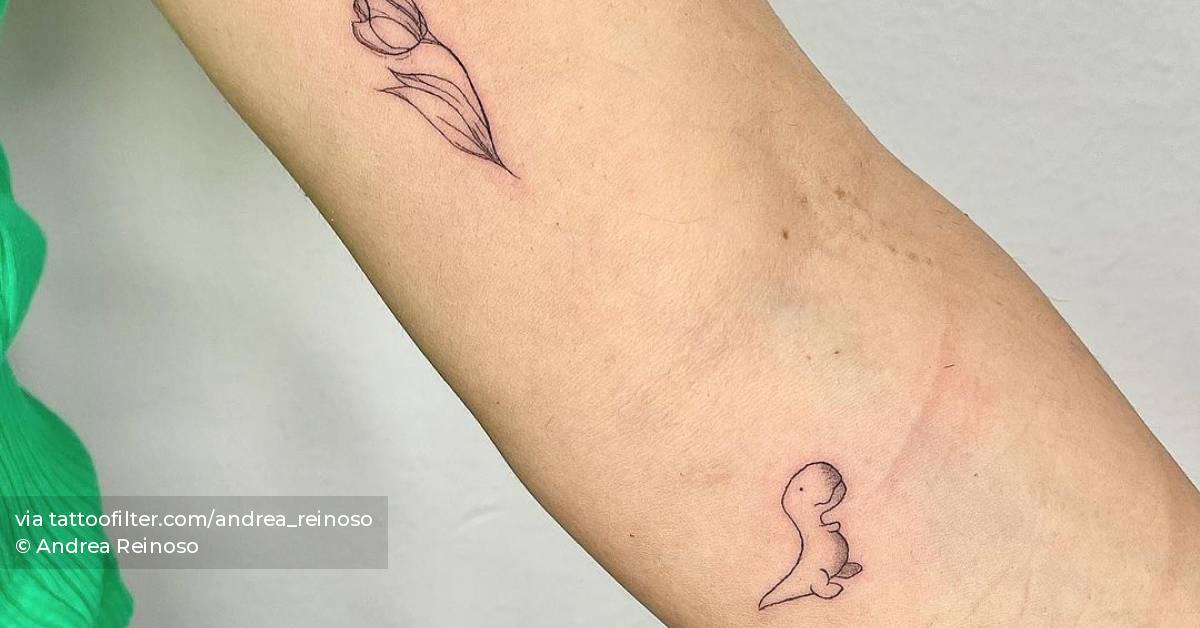 Fine line tulip and t-rex tattoos located on the arm.