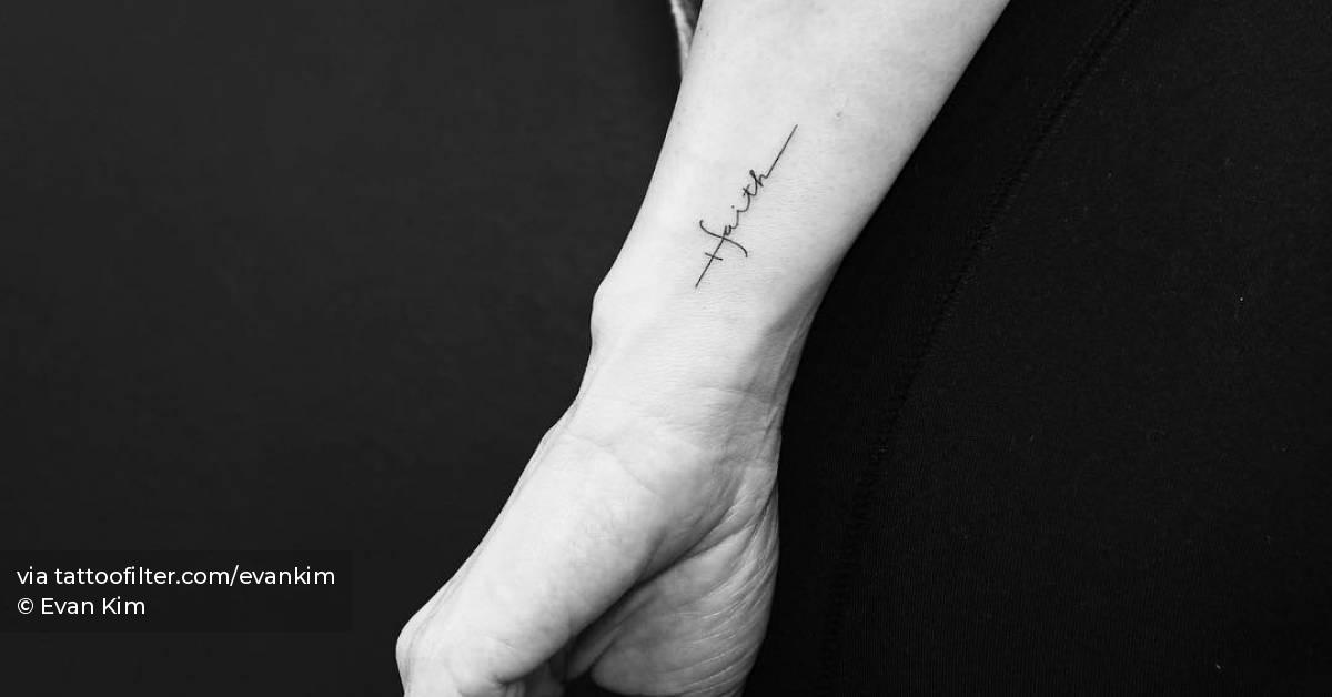 "Faith" cross lettering tattoo located on the wrist.