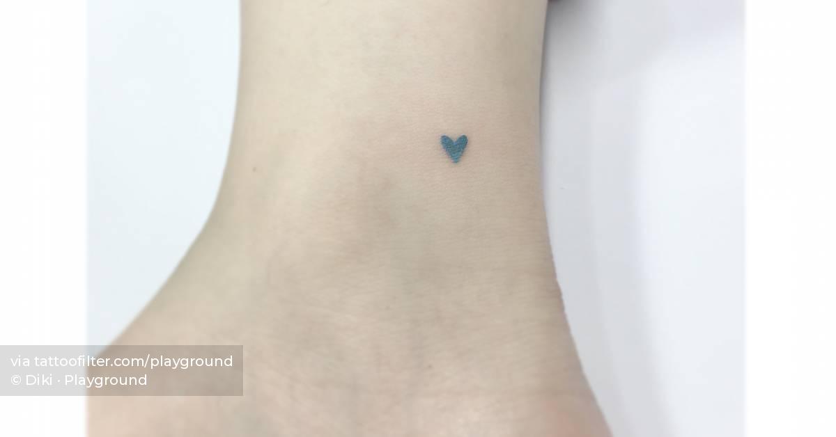 Mini blue heart tattoo located on the ankle.
