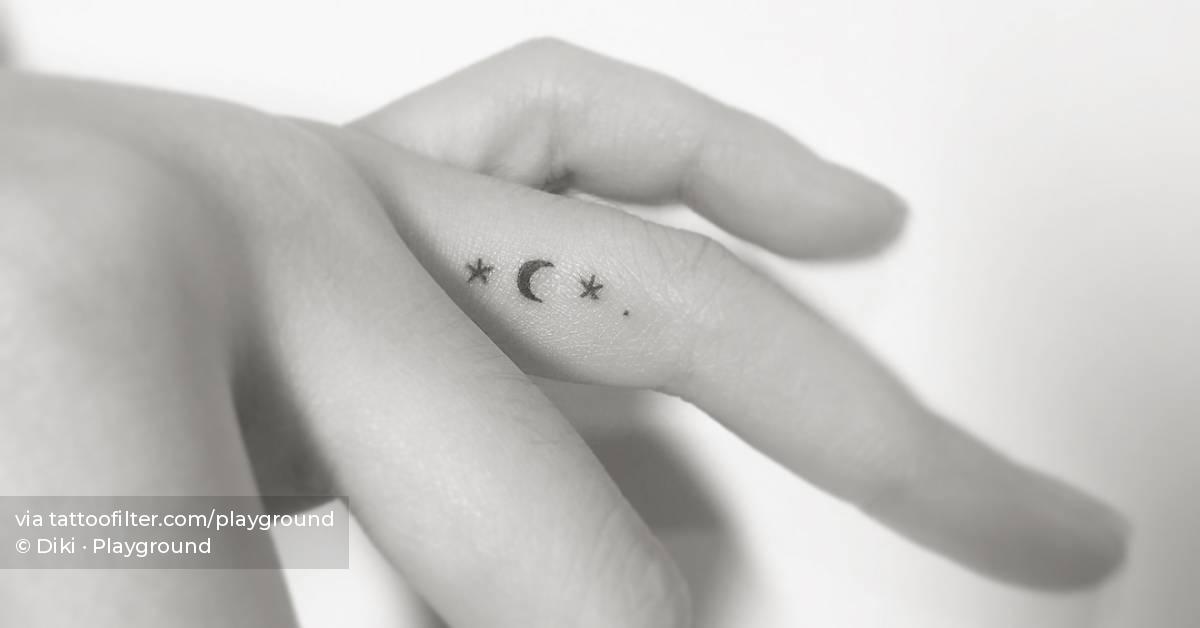 Tiny stars and moon tattoo located on the finger.