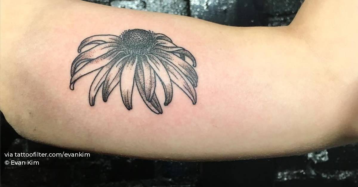Black eyed susan tattoo located on the inner arm.