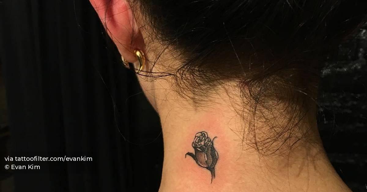 Rose head tattoo located on the back of the neck.