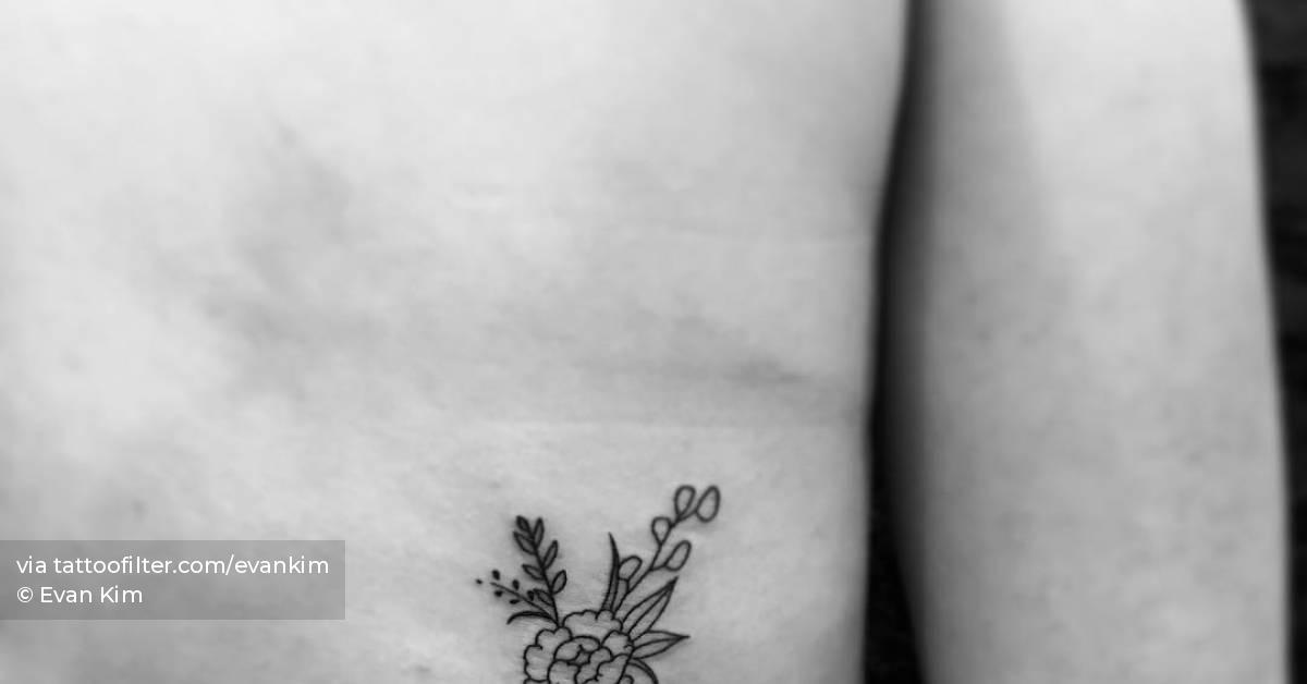 Minimalistic style peony tattoo located on the back.