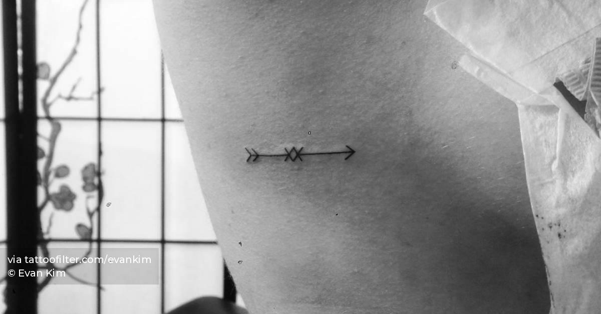 Minimalistic style arrow tattoo located on the side