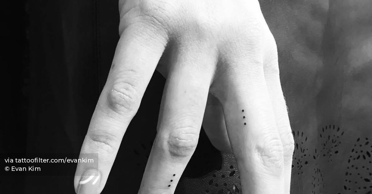 Minimalistic style ellipsis tattoo located on the