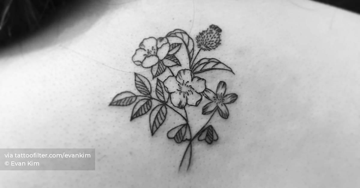 Flower bouquet tattoo located on the upper back.