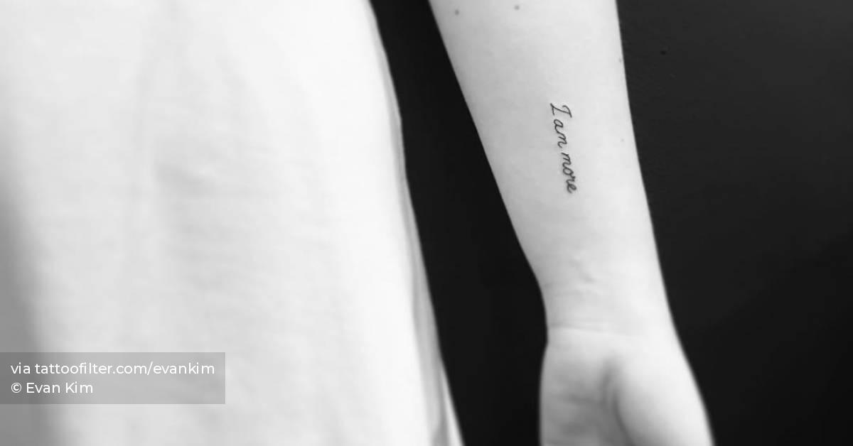 "I am more" lettering tattoo handwritten on the wrist.