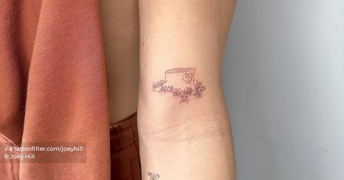 Single needle tree stump tattoo located on the bicep.