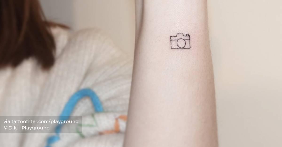 Tiny minimalistic tattoo of a camera located on the