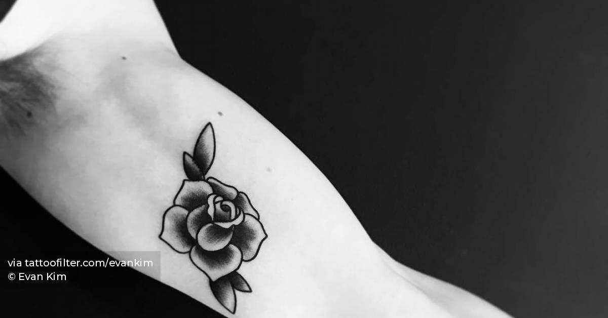 Traditional style rose head tattoo located on the inner