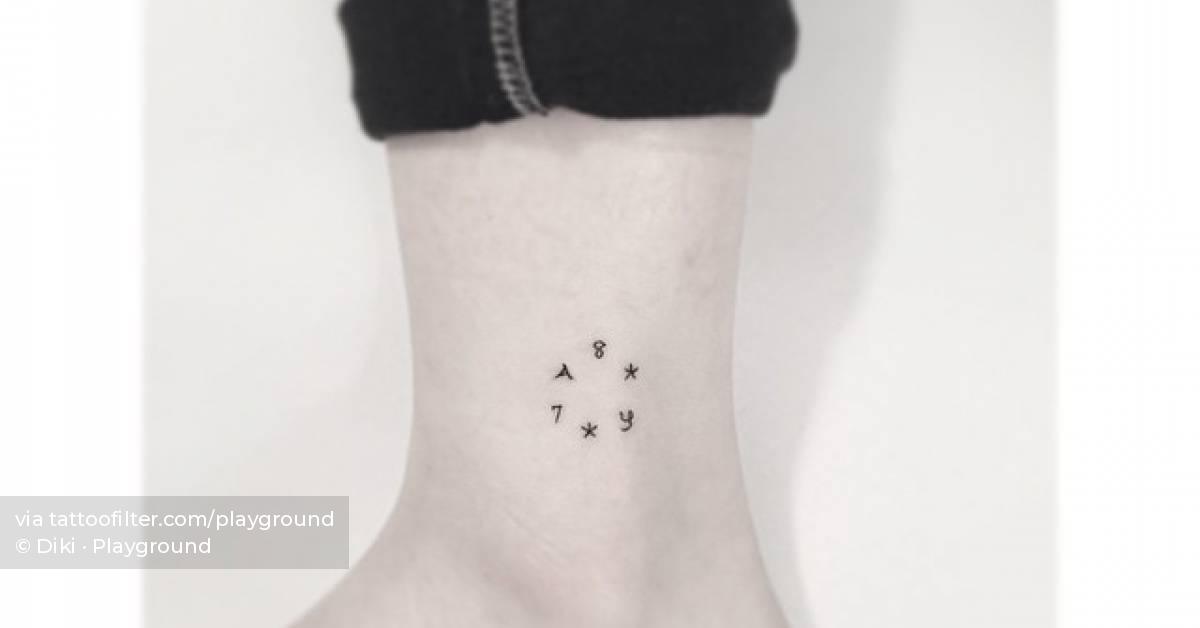 Minimalistic numbers and letters tattoo located on the