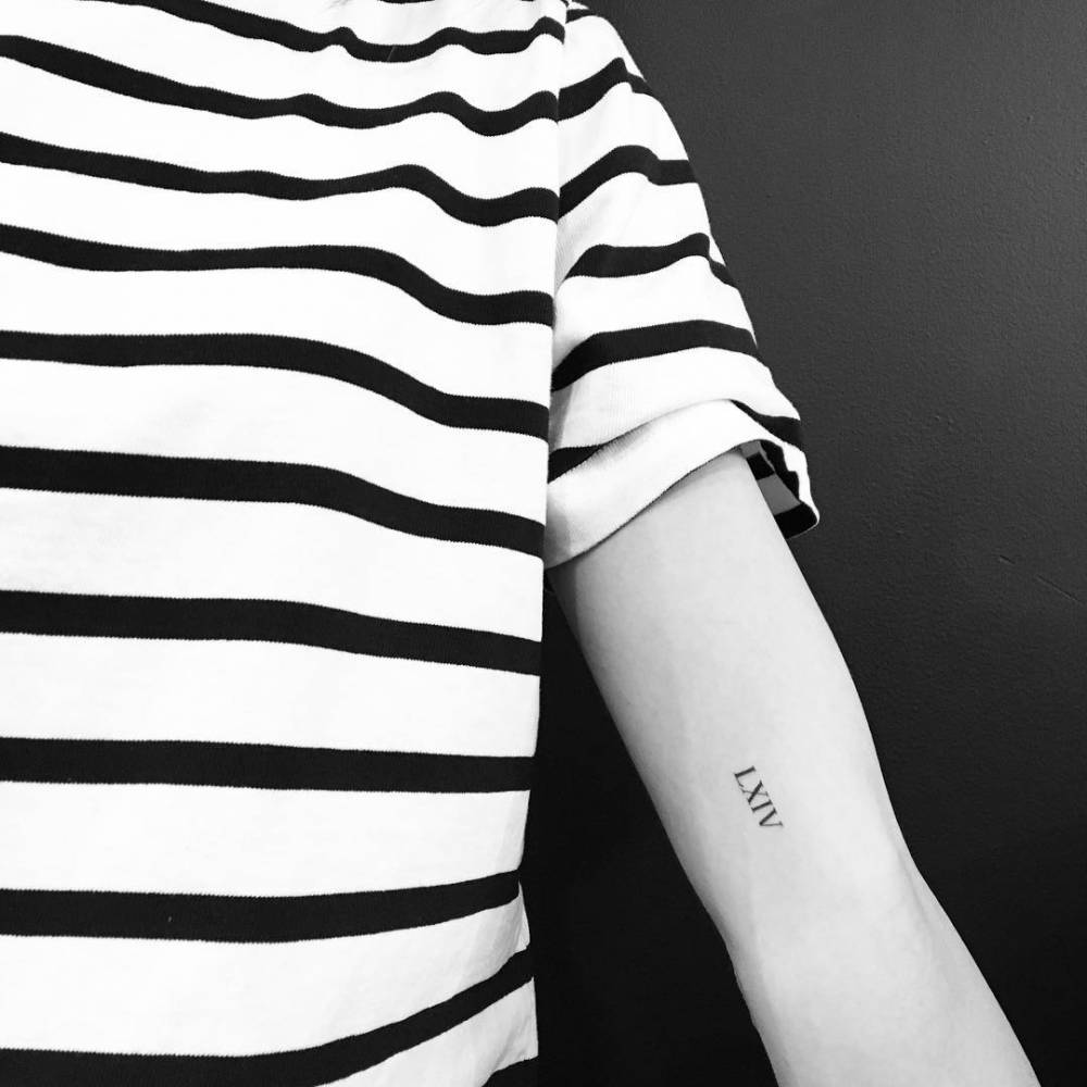 Roman Numeral Tattoo Located On The Inner Arm 