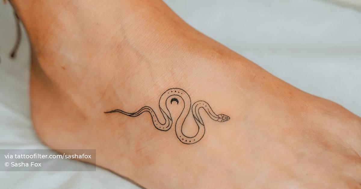 Cute snake tattoo located on the foot.