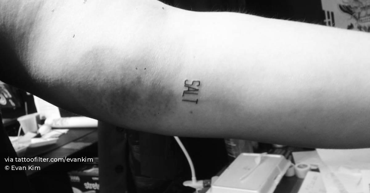 Tattoo of the word "salt" handwritten on the inner