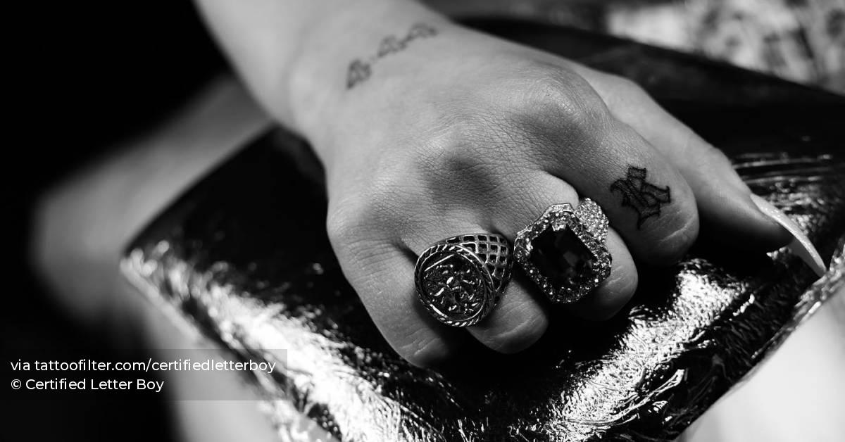 Minimalistic letter "R" tattoo located on Claudia