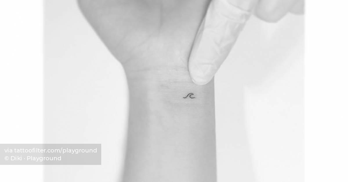 Super tiny wave tattoo located on the wrist.