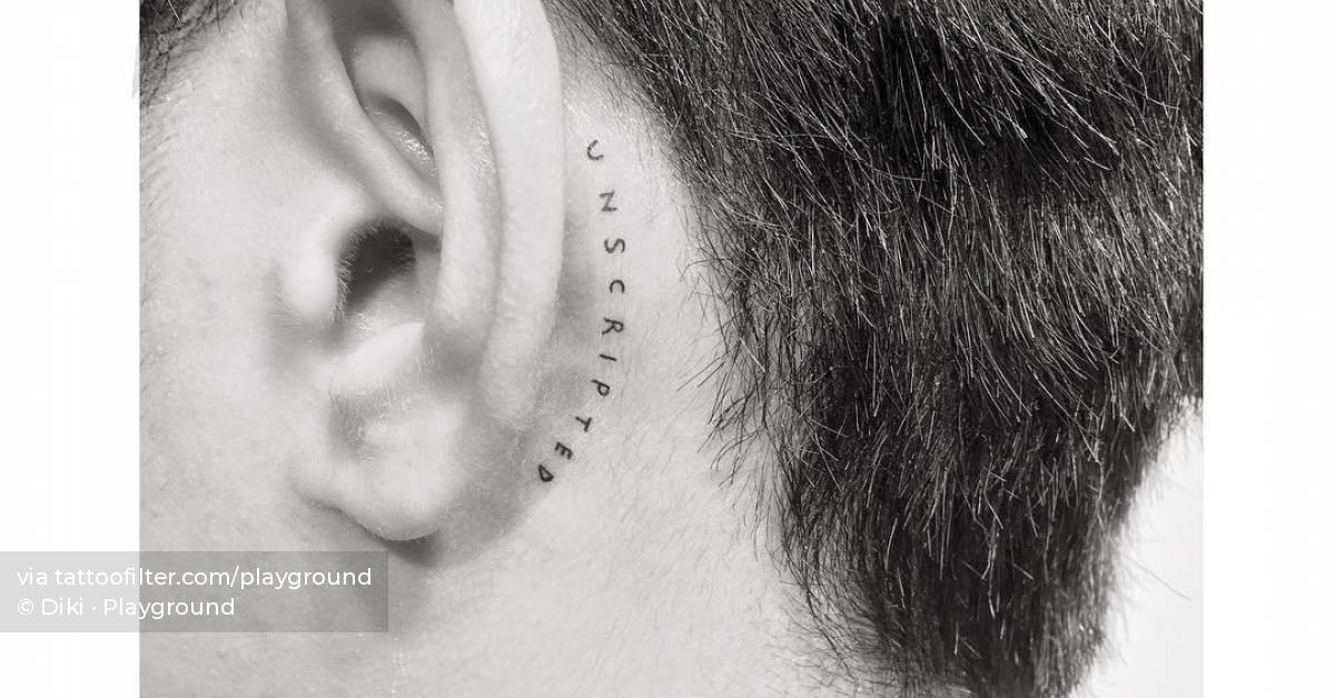 "Unscripted" lettering tattoo located behind the ear.