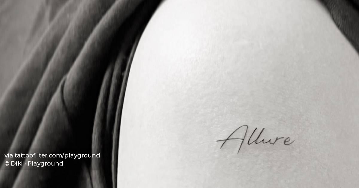 Tattoo of the word "allure" located on the upper arm.