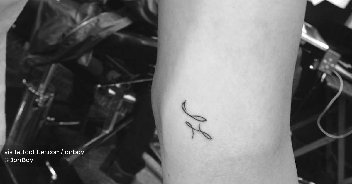 Initials "I.L." tattooed on the inner arm.