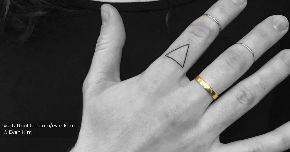 Tiny triangle tattoo done on the finger, minimalistic